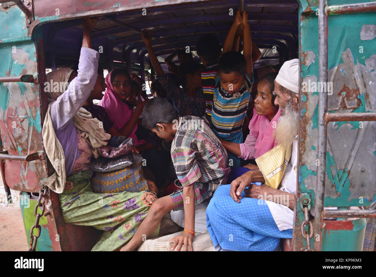 Rohingya refugees are seen in a mini-truck before being shift to a ...