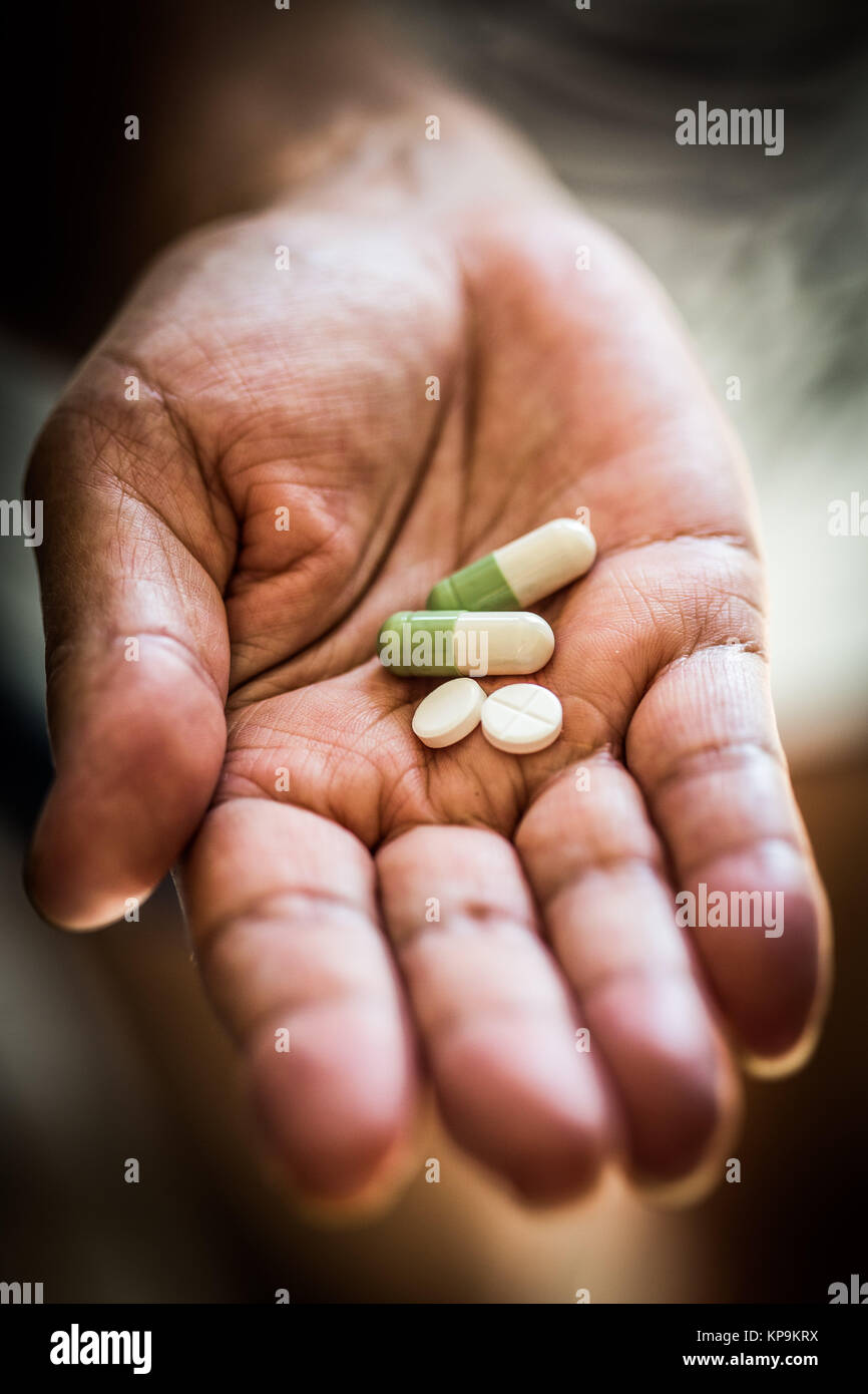 Assortment of tablets and pills in a Woman's hand Stock Photo - Alamy