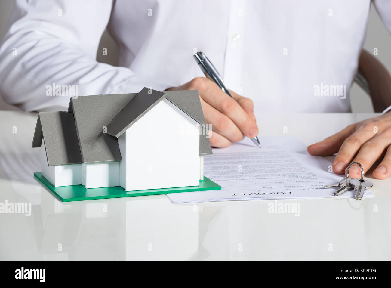 Businessman Signing House Contract Stock Photo - Alamy