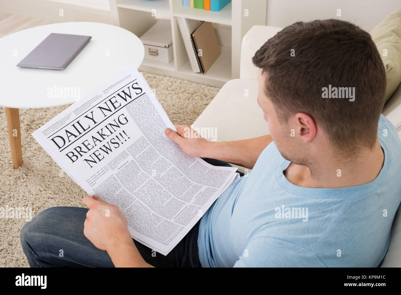 Man Reading Breaking News On Newspaper At Home Stock Photo - Alamy