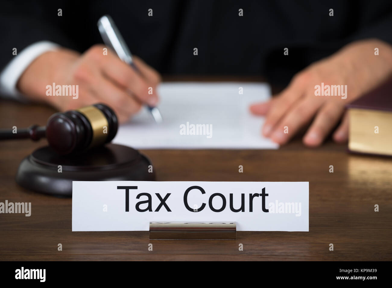 Tax Court Nameplate On Table With Judge Writing In Background Stock ...