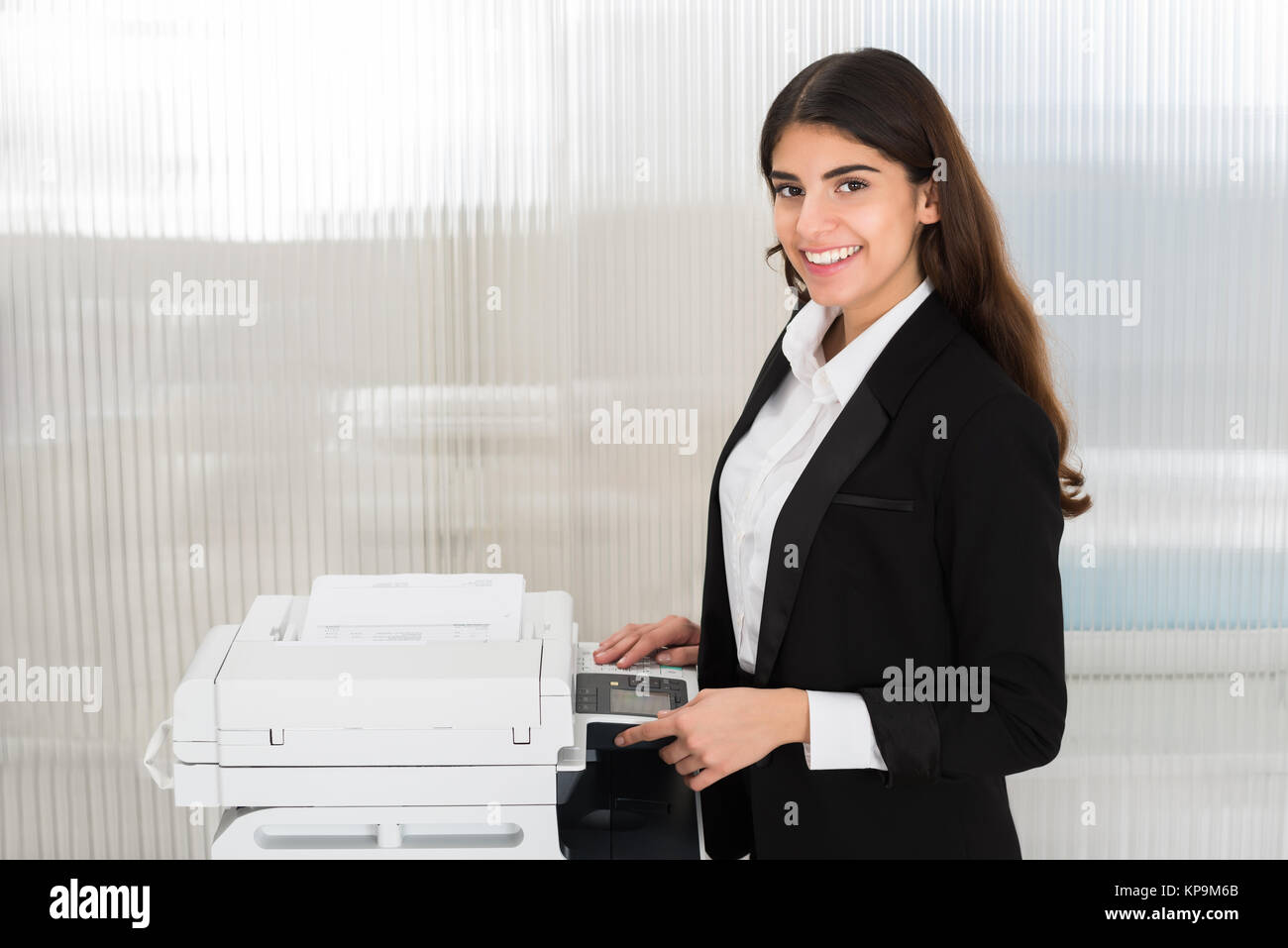 Businesswoman Using Photocopy Machine In Office Stock Photo - Alamy