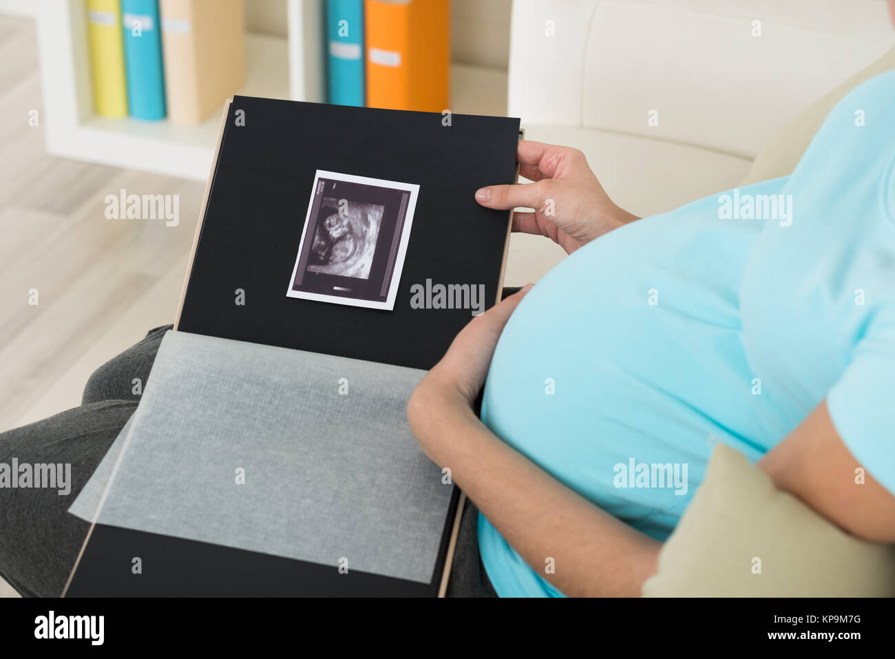Midsection Of Pregnant Woman With Ultrasound Scan Stock Photo - Alamy