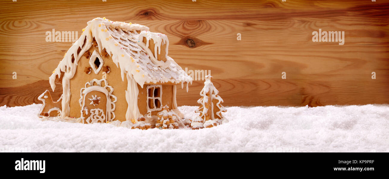 Gingerbread house on wooden background.Christmas background.White snow ...