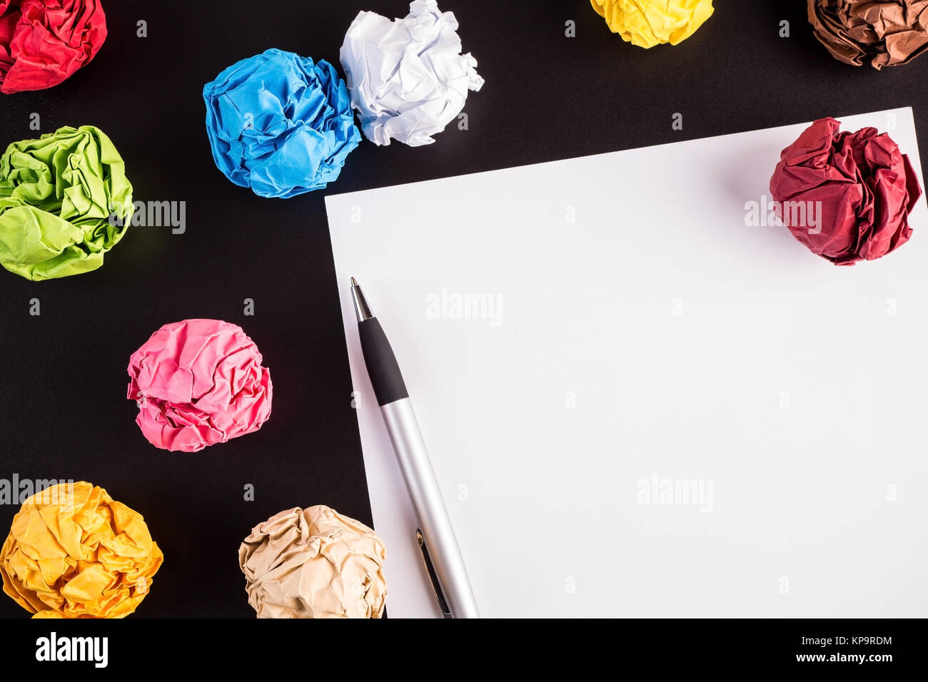 Creased color papers with white paper and ballpen Stock Photo - Alamy