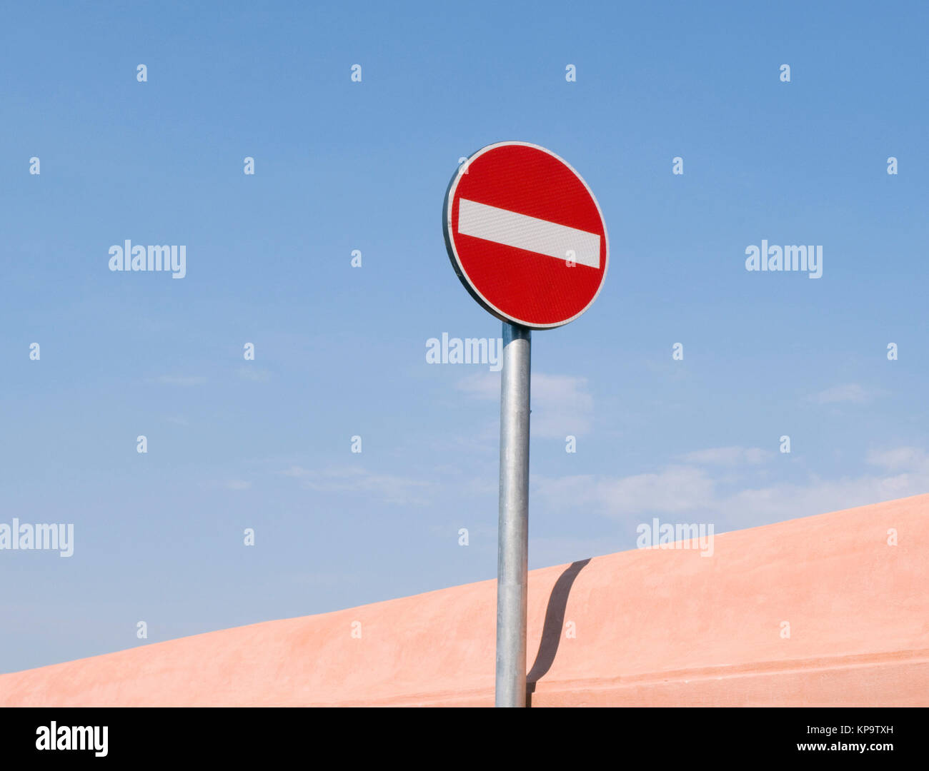 No entry traffic sign post and a wall Stock Photo - Alamy