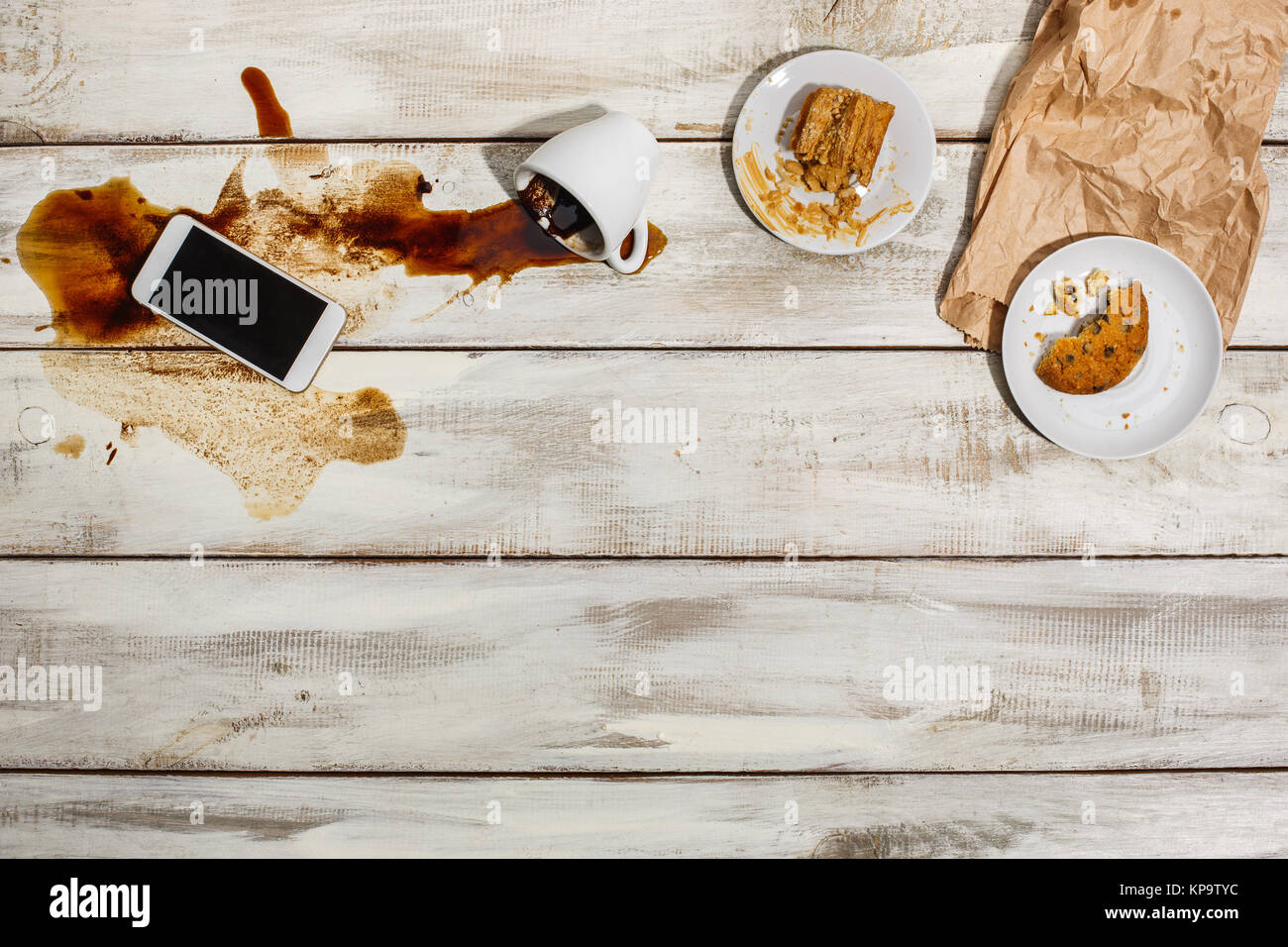 Cup of coffee spilled on wooden table Stock Photo - Alamy
