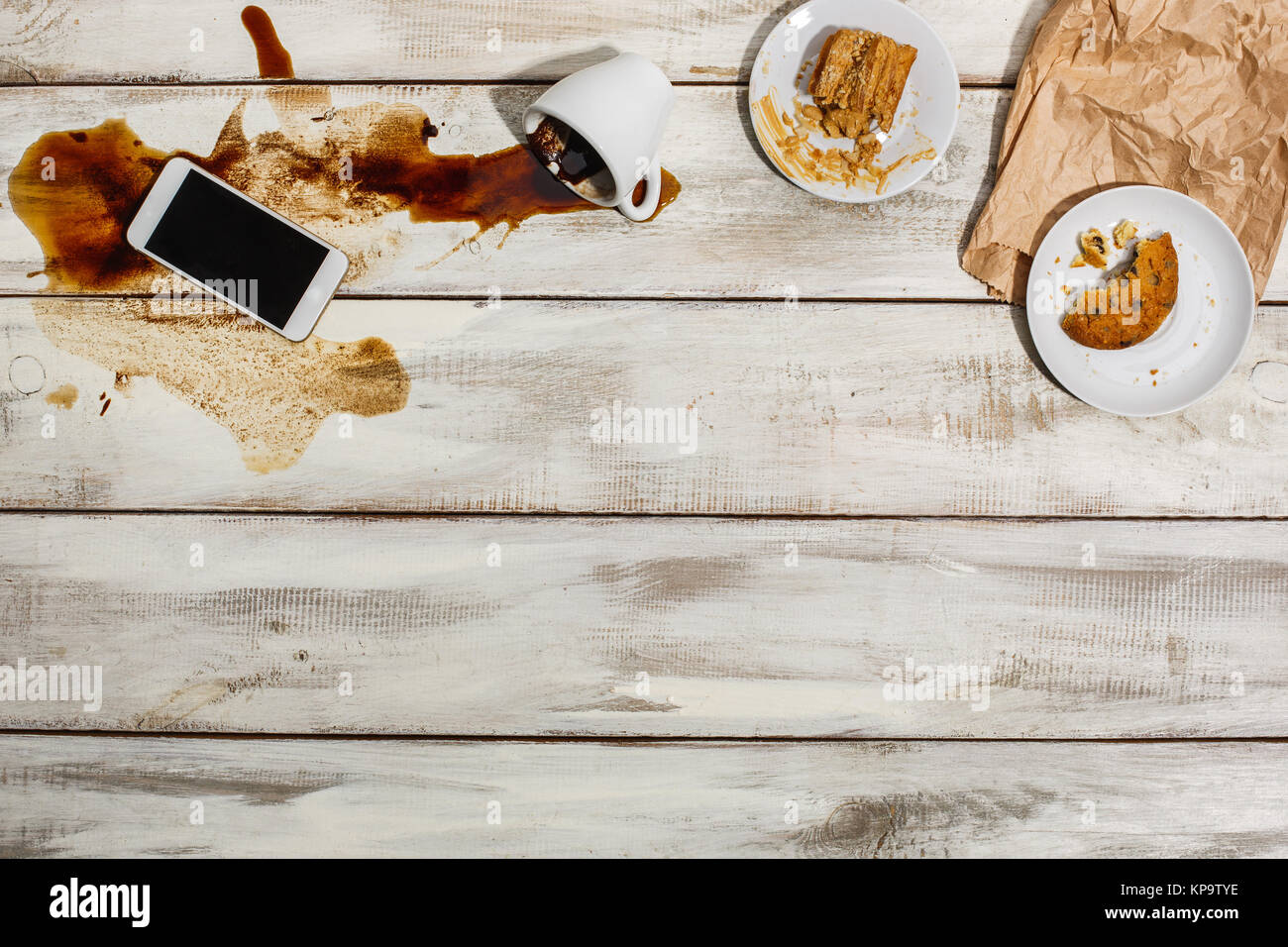 Cup of coffee spilled on wooden table Stock Photo - Alamy