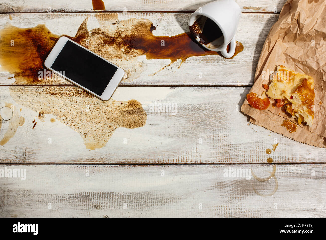 Cup of coffee spilled on wooden table Stock Photo - Alamy