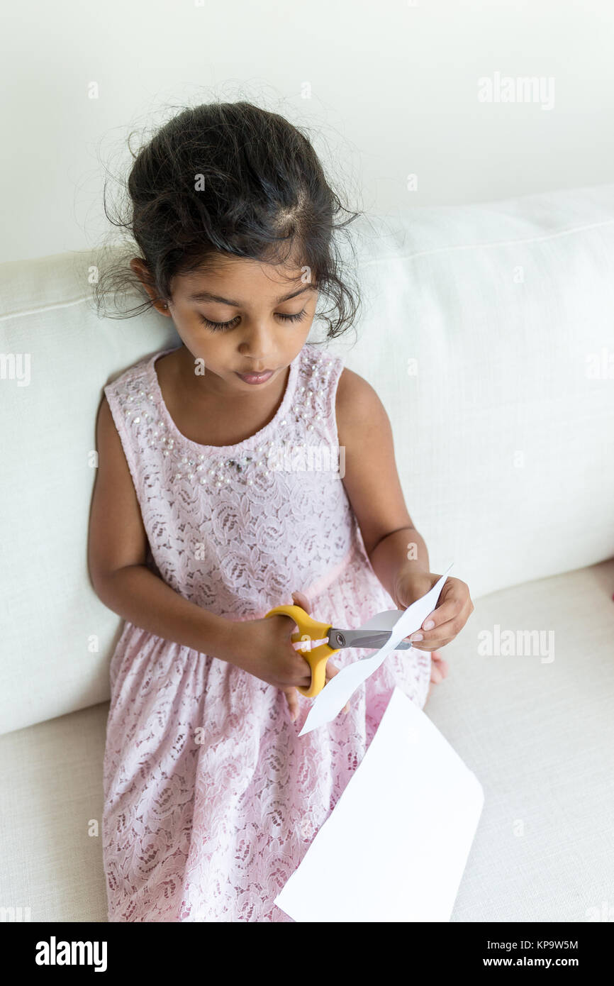 Little girl scissor cutting paper hi-res stock photography and images ...