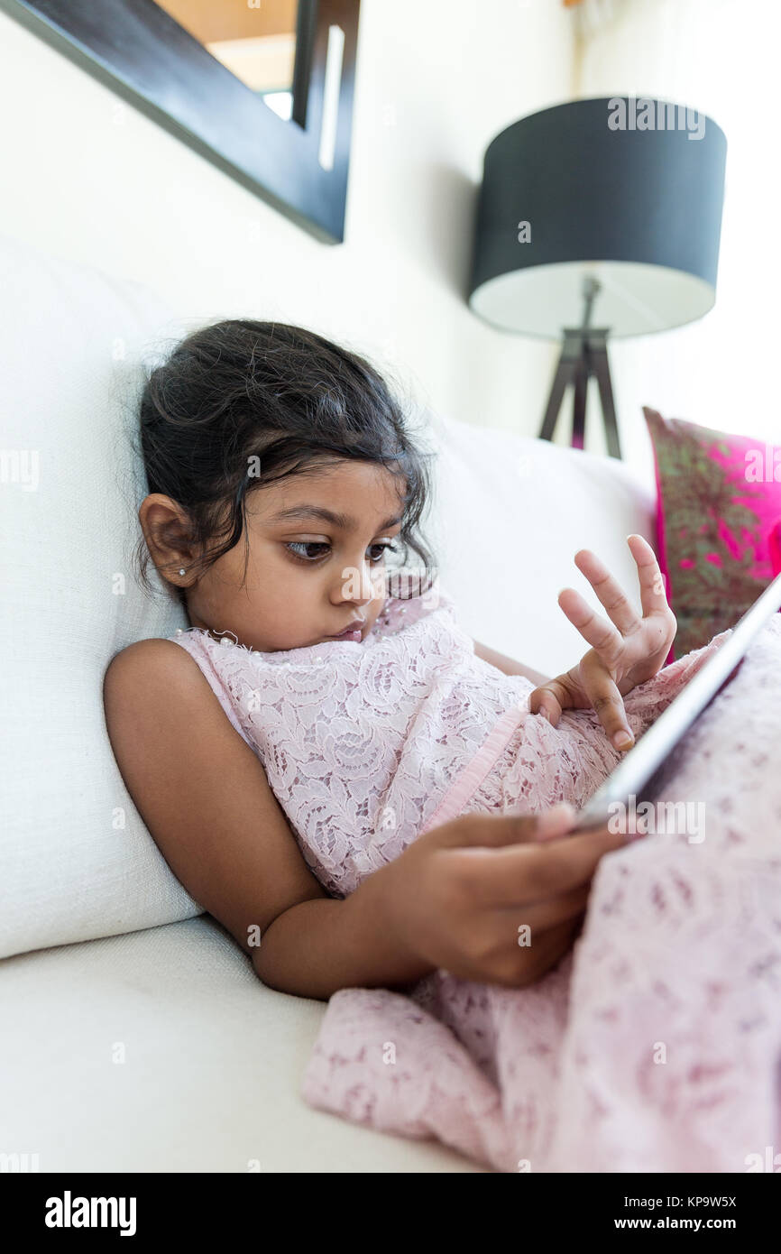 Indian girl using the tablet at home Stock Photo - Alamy