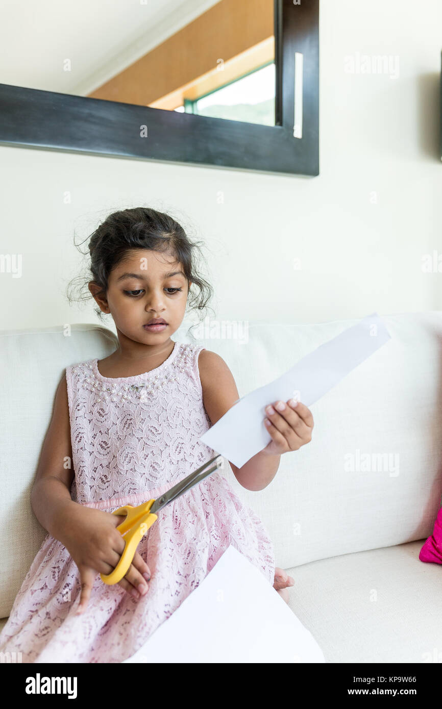 Little girl use the scissor for cutting paper Stock Photo - Alamy