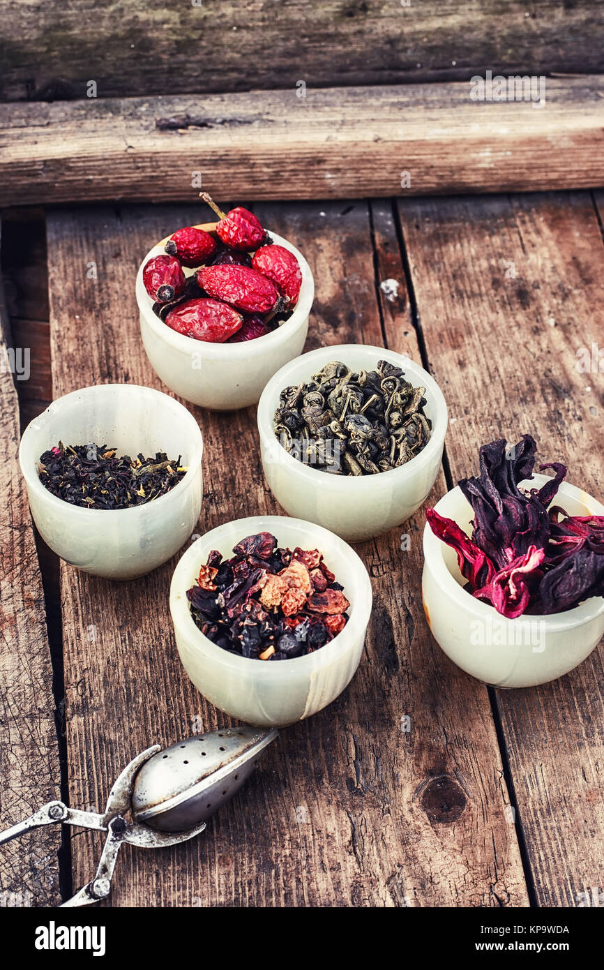 Tea leaves of different varieties in the stacks of custard and spoon ...