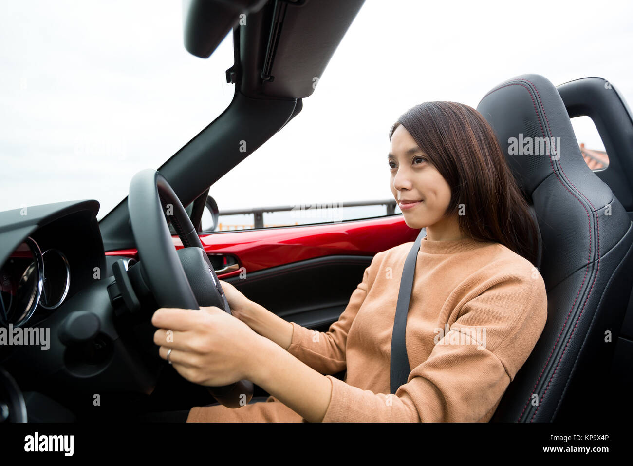 Woman driving convertible car Stock Photo - Alamy