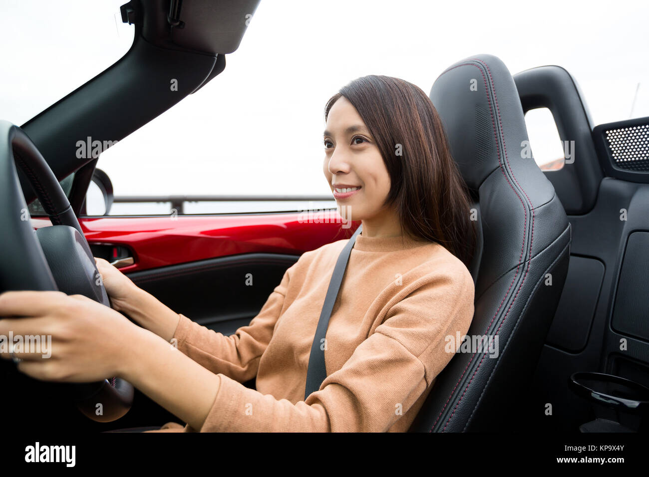Woman driving a convertible car Stock Photo - Alamy
