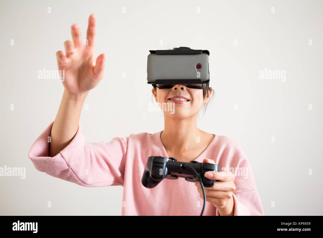 Young Woman play game with vr device and hand want to touch something ...