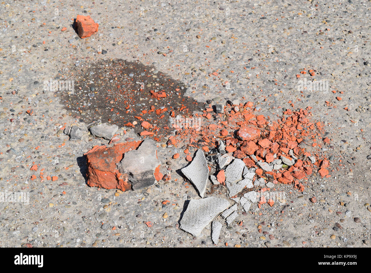 The broken bricks and pieces of slate on asphalt Stock Photo - Alamy