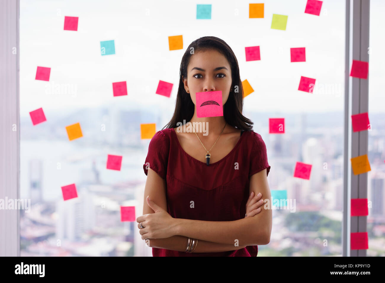 Busy Person Holds Sticky Note On Mouth With Emoticon Stock Photo - Alamy