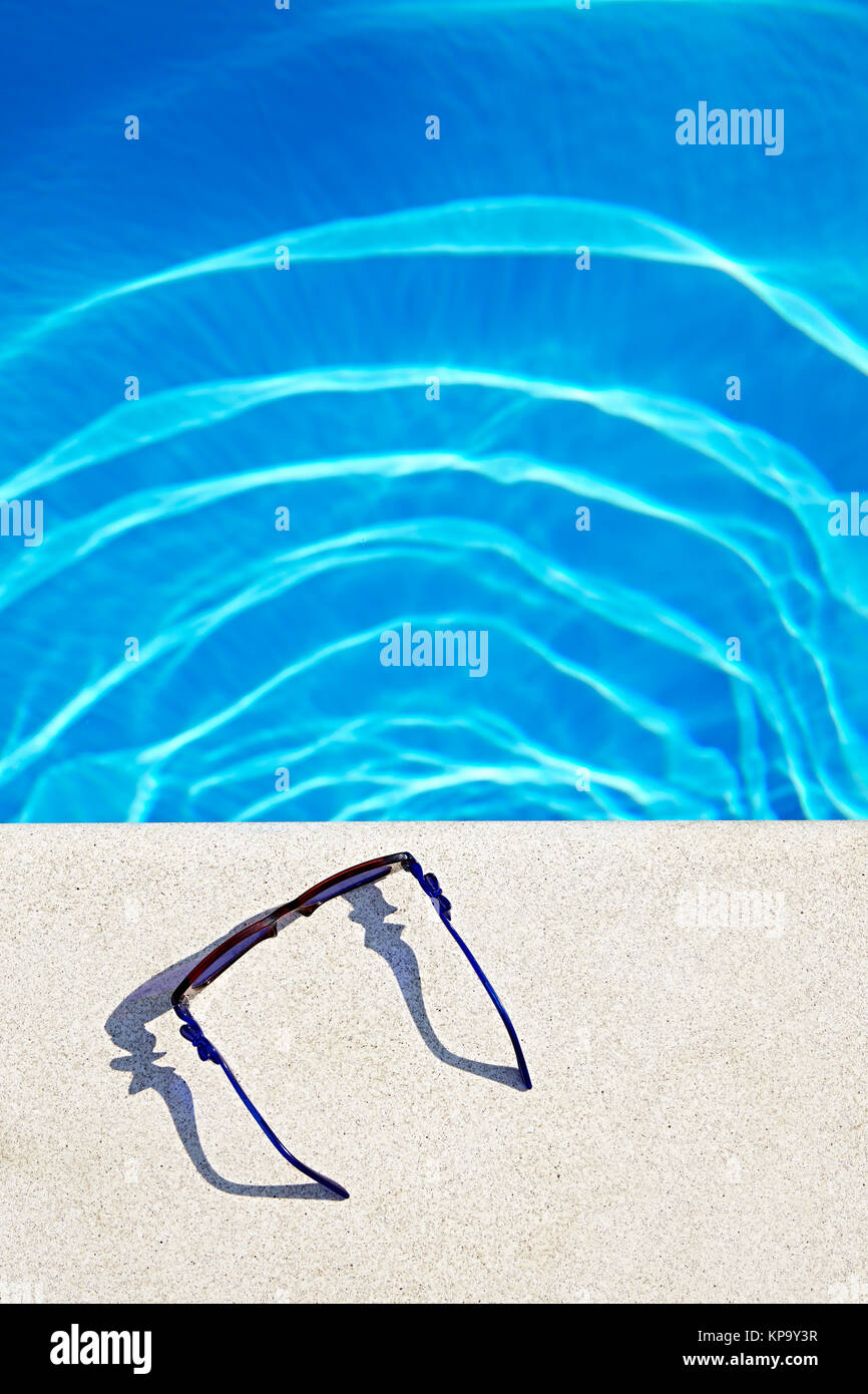 Sunglasses at the swimming pool Stock Photo - Alamy