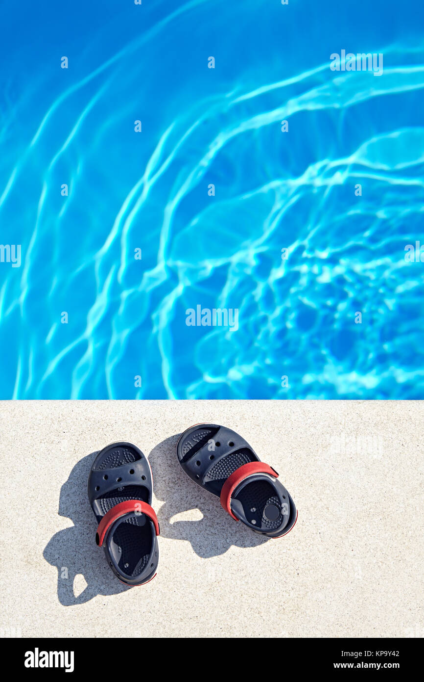 Sandals at the swimming pool Stock Photo - Alamy