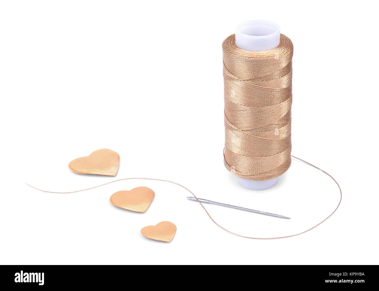 The spool of thick nylon thread, a needle and three tissue hearts of ...