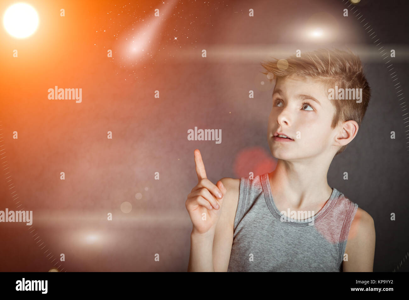 Curious Boy Pointing his Up to Glowing Lights Stock Photo - Alamy