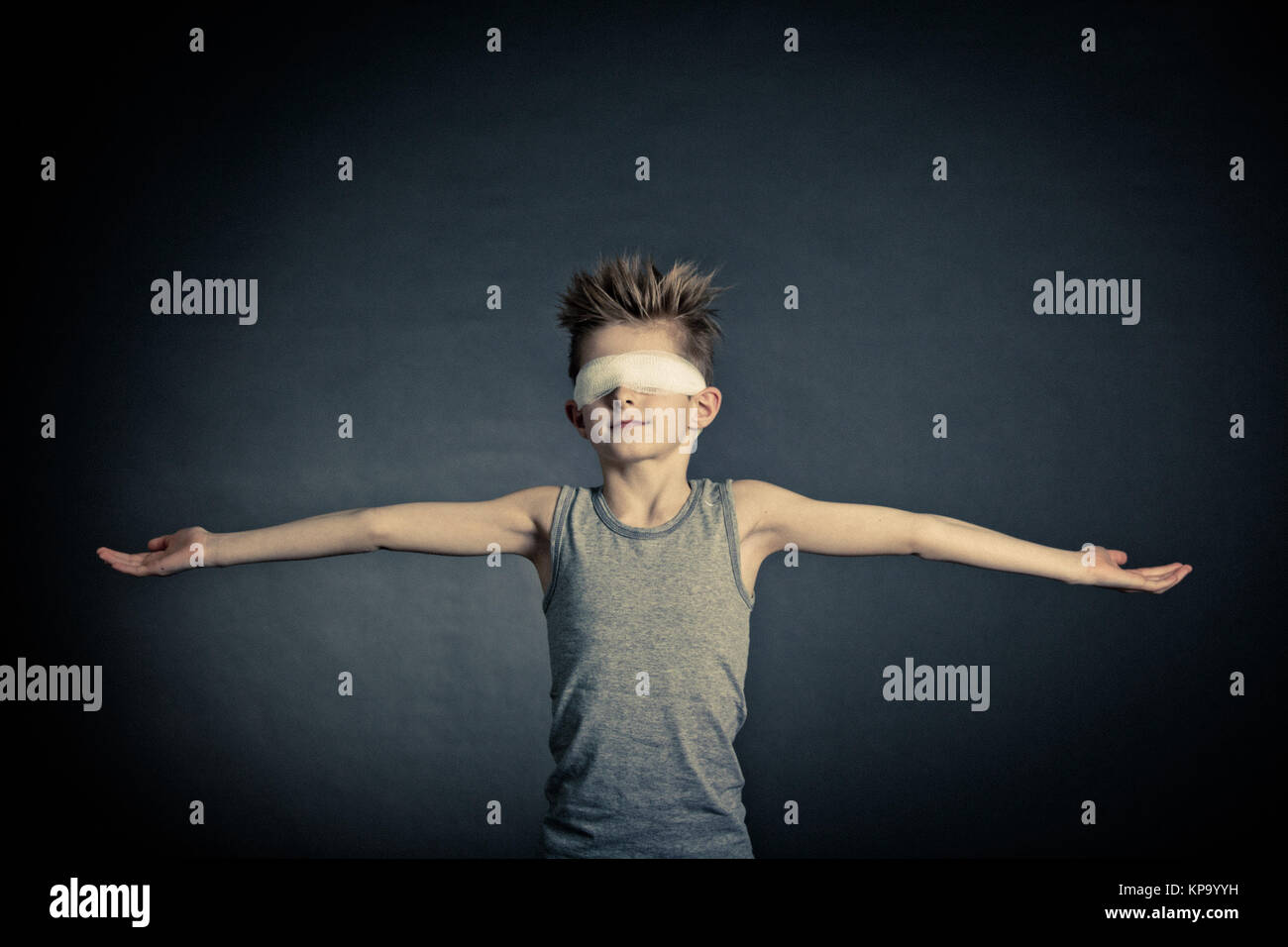 Young Boy with Eyes Covered Raising Arms on Sides Stock Photo - Alamy