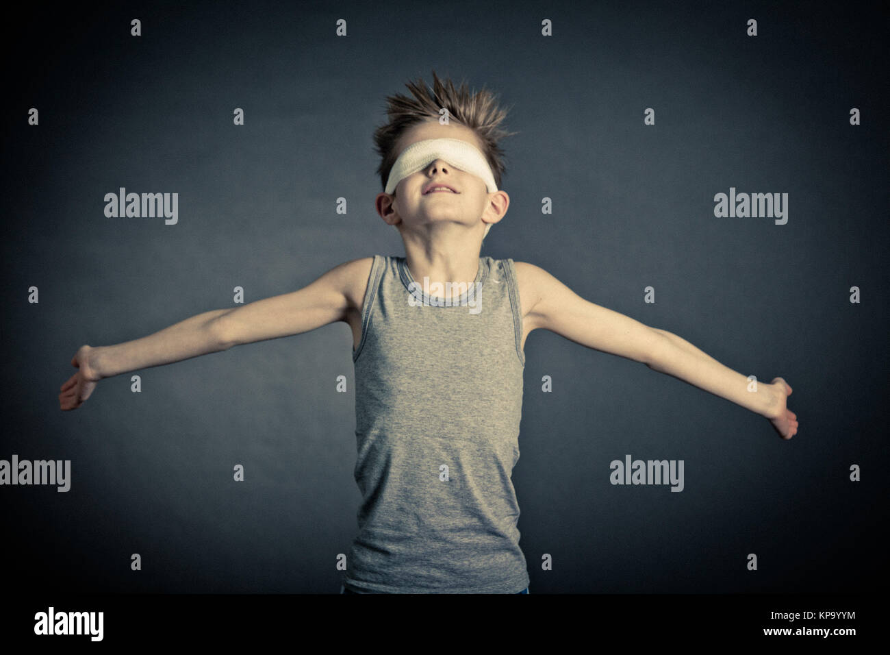 Young Boy with Wide Open Arms and Covered Eyes Stock Photo - Alamy