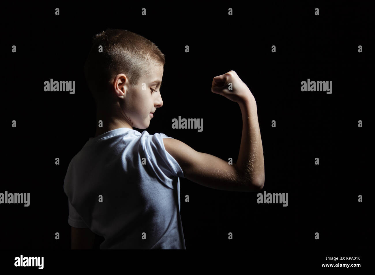 Boy showing off his muscles hi-res stock photography and images - Alamy