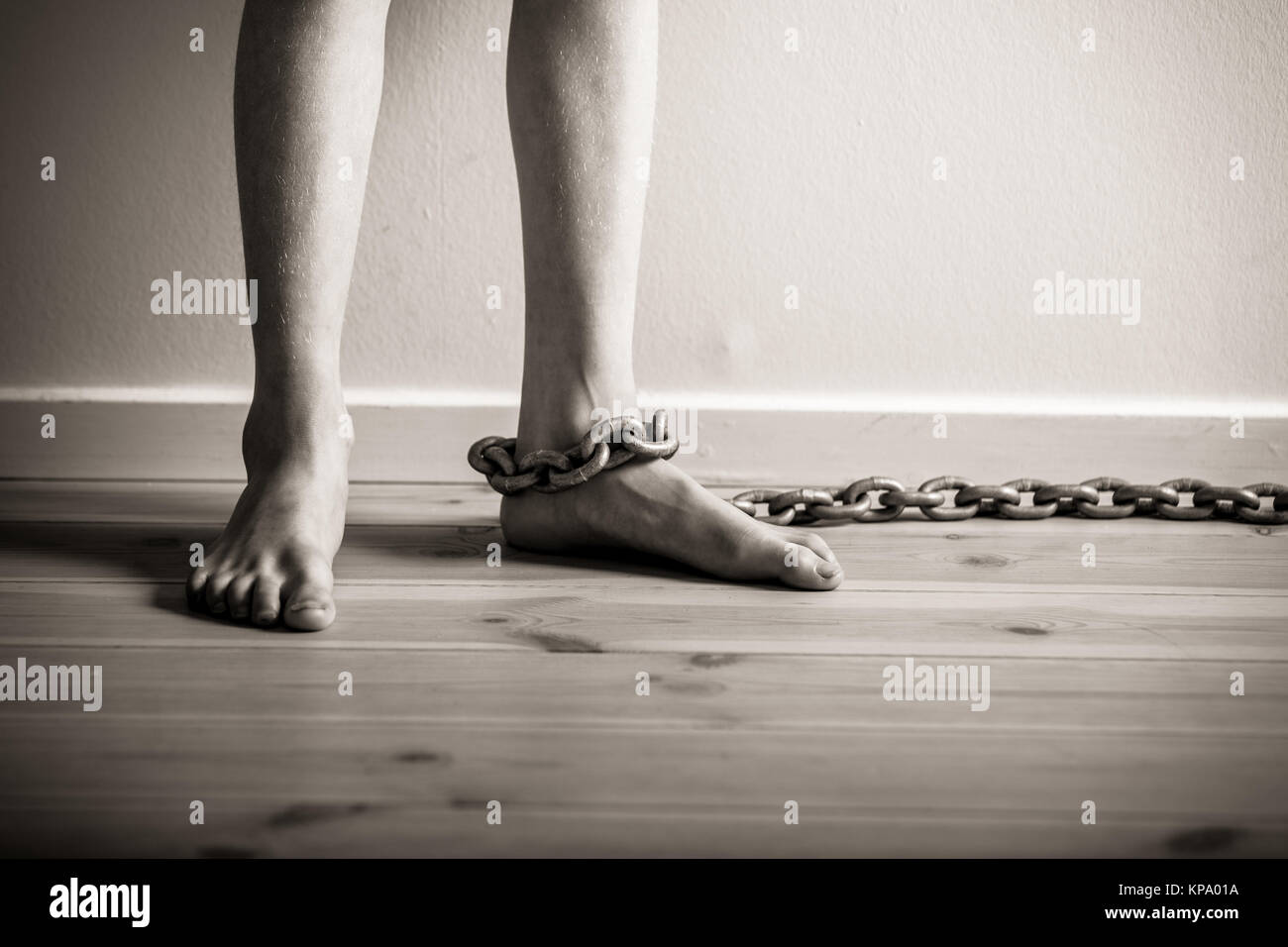 Young Boy Standing in Bare Feet with Chain Stock Photo - Alamy