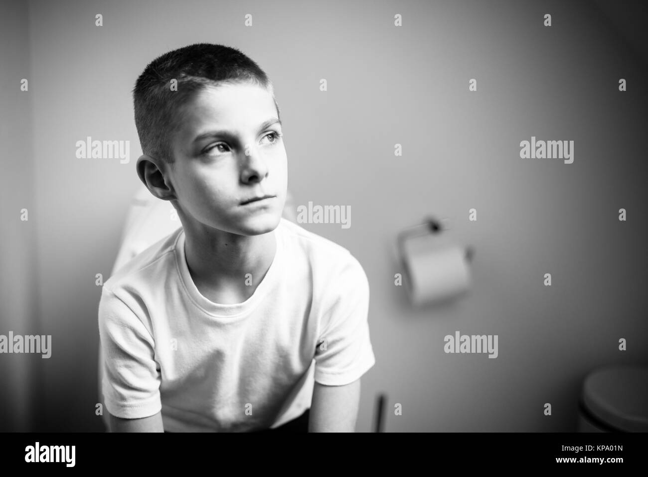 Young Boy Sitting On The Toilet Highres Stock Photo