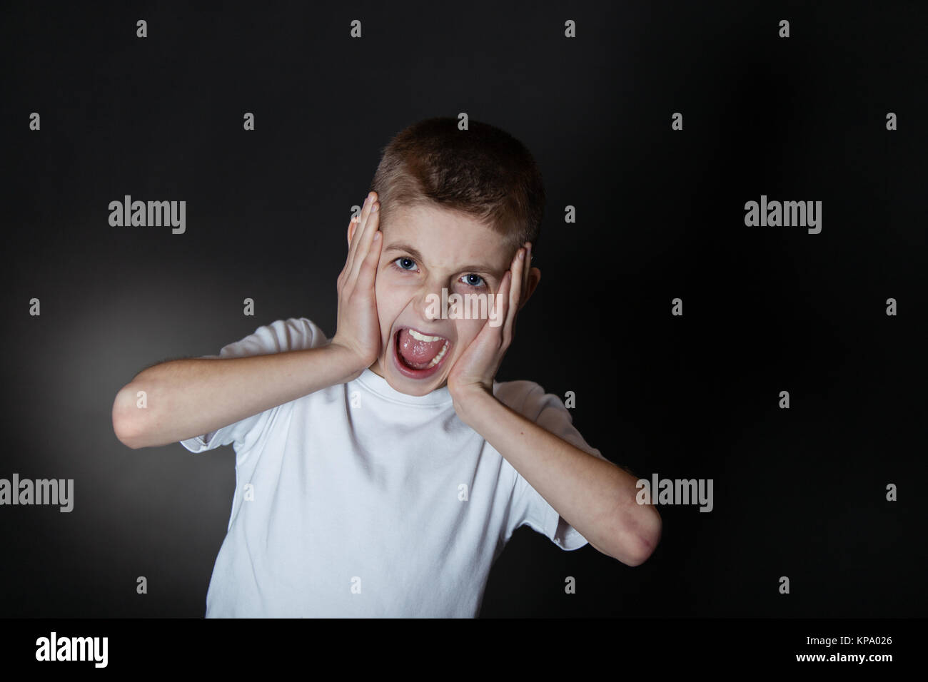 Angry Boy Shouting with Hands Holding on his Face Stock Photo - Alamy