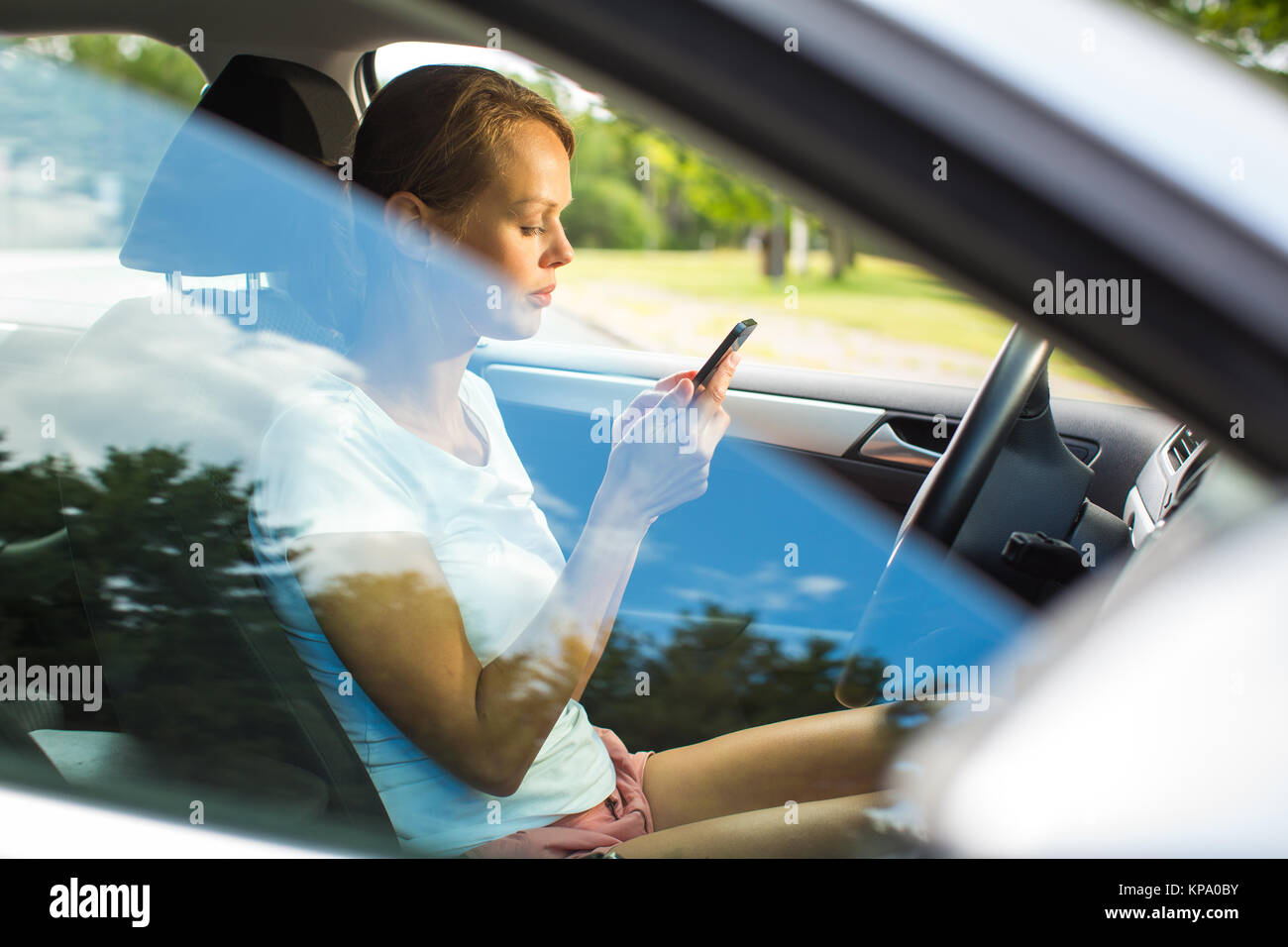Young woman driving her car, on her way home from work Stock Photo - Alamy