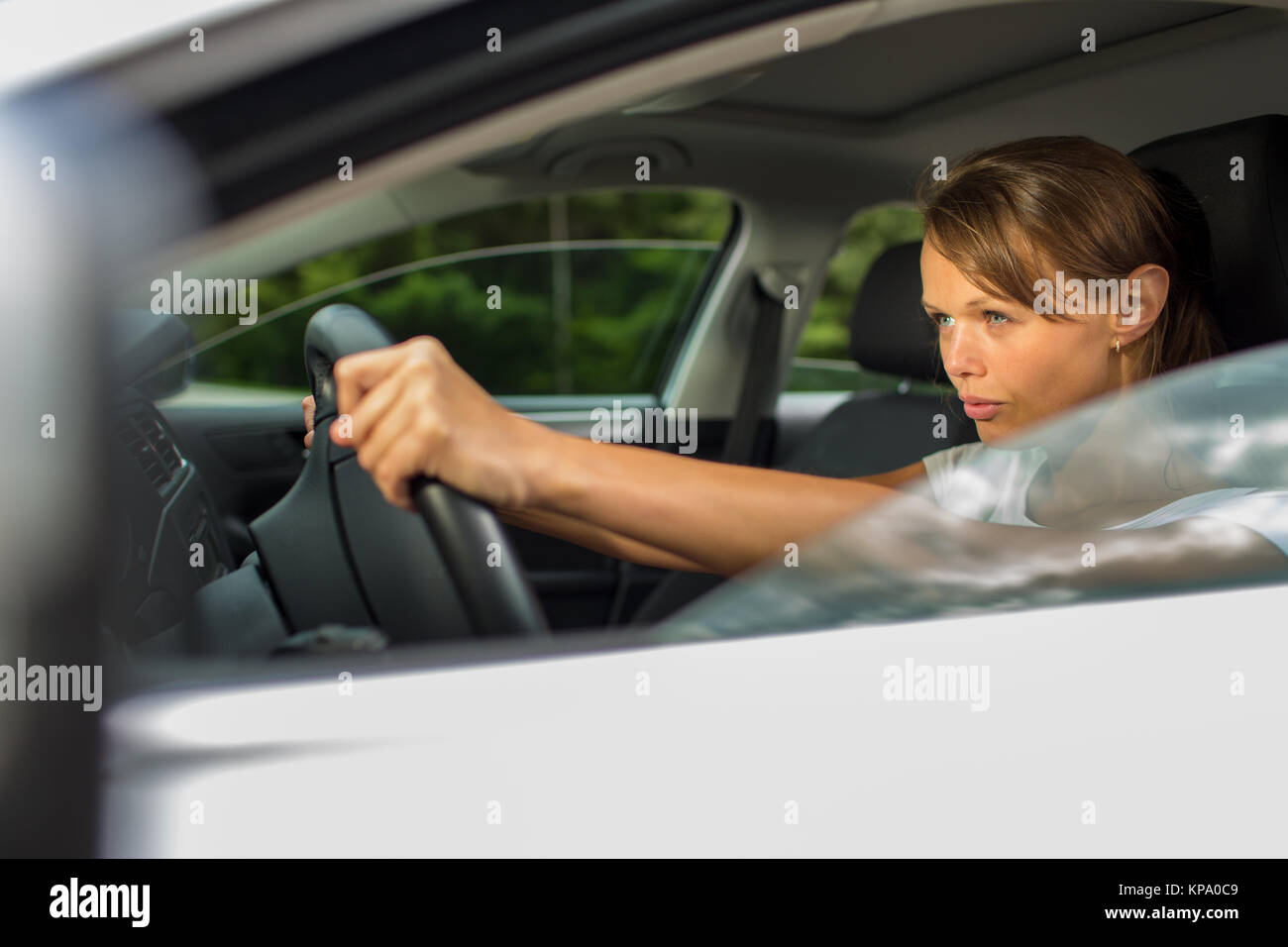 Young woman driving her car, on her way home from work Stock Photo - Alamy