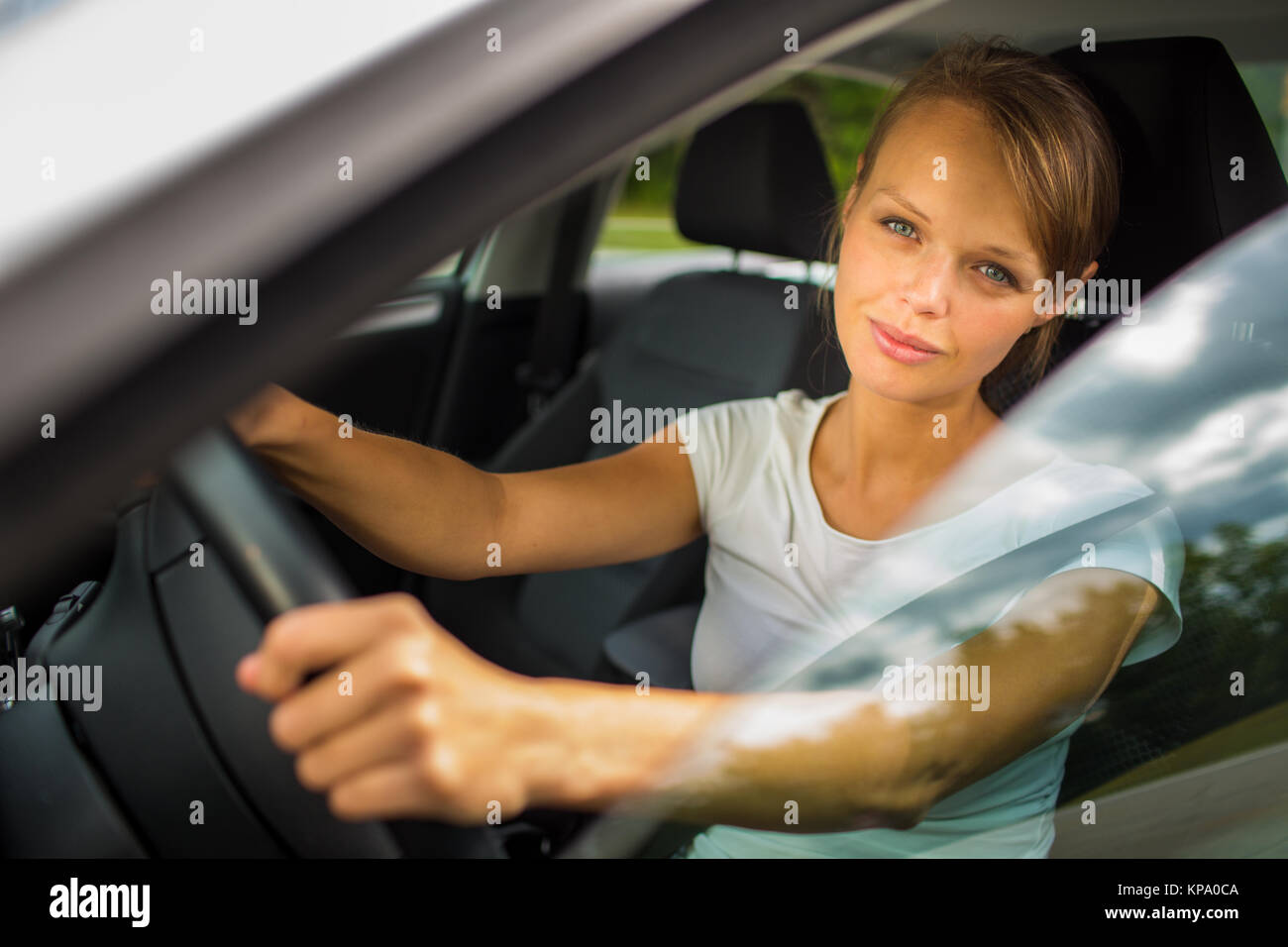 Young woman driving her car, on her way home from work Stock Photo - Alamy
