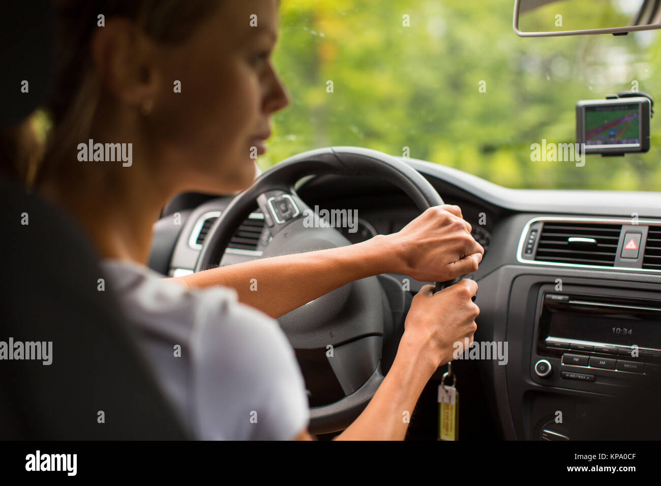 Young woman driving her car, on her way home from work Stock Photo - Alamy