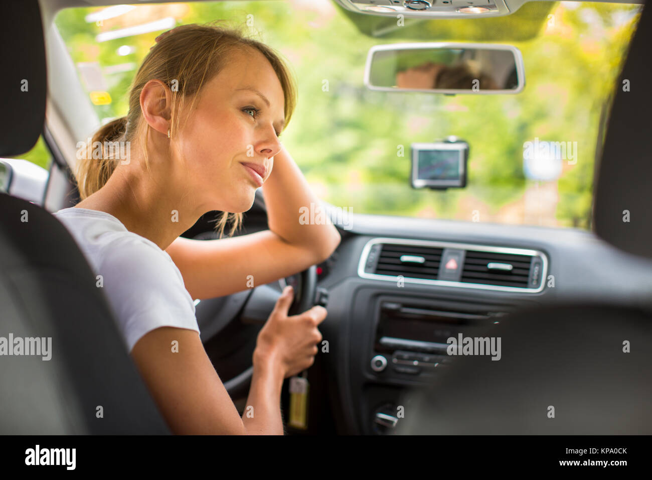 Young woman driving her car, on her way home from work Stock Photo - Alamy