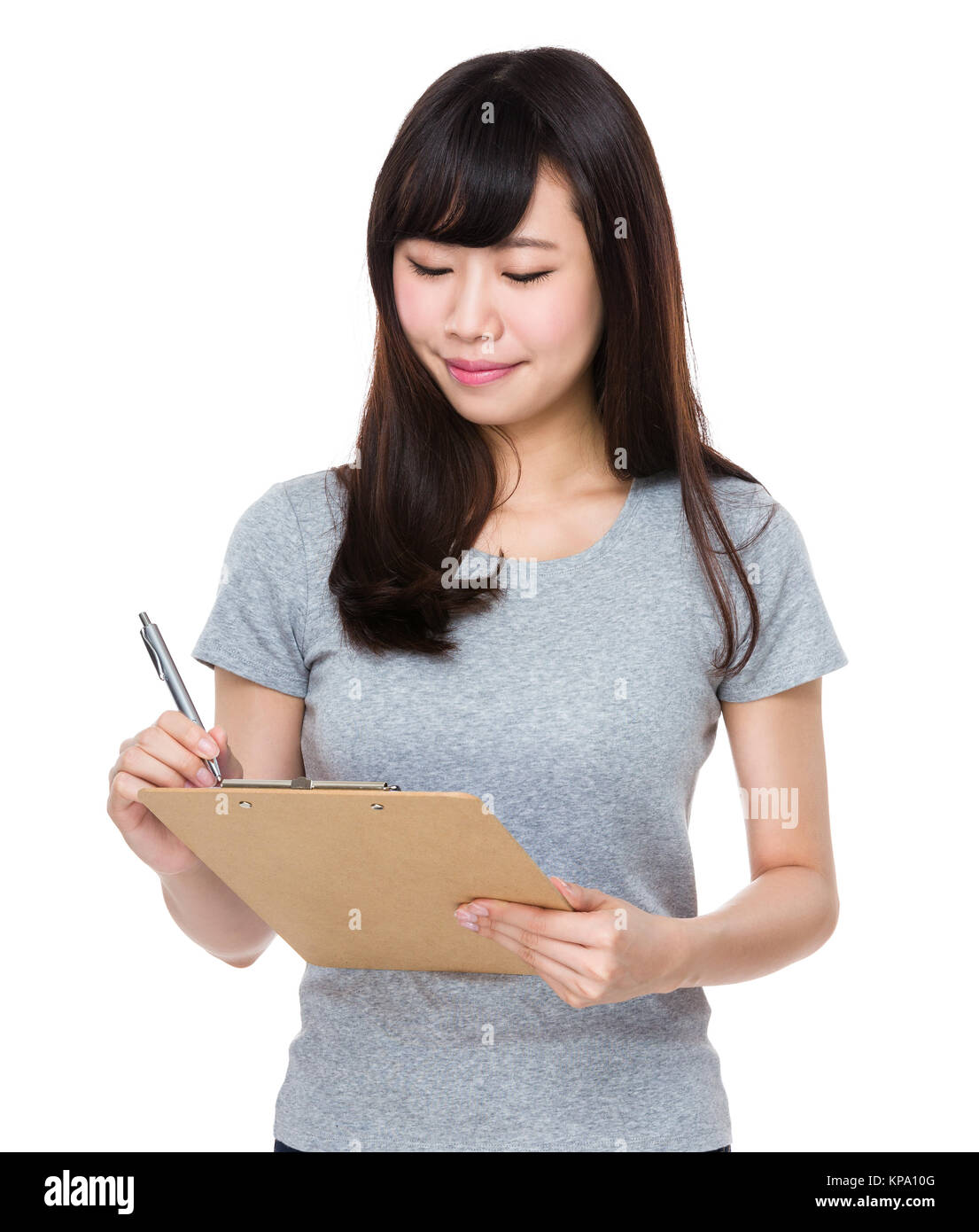 Asian woman take note on clipboard Stock Photo - Alamy