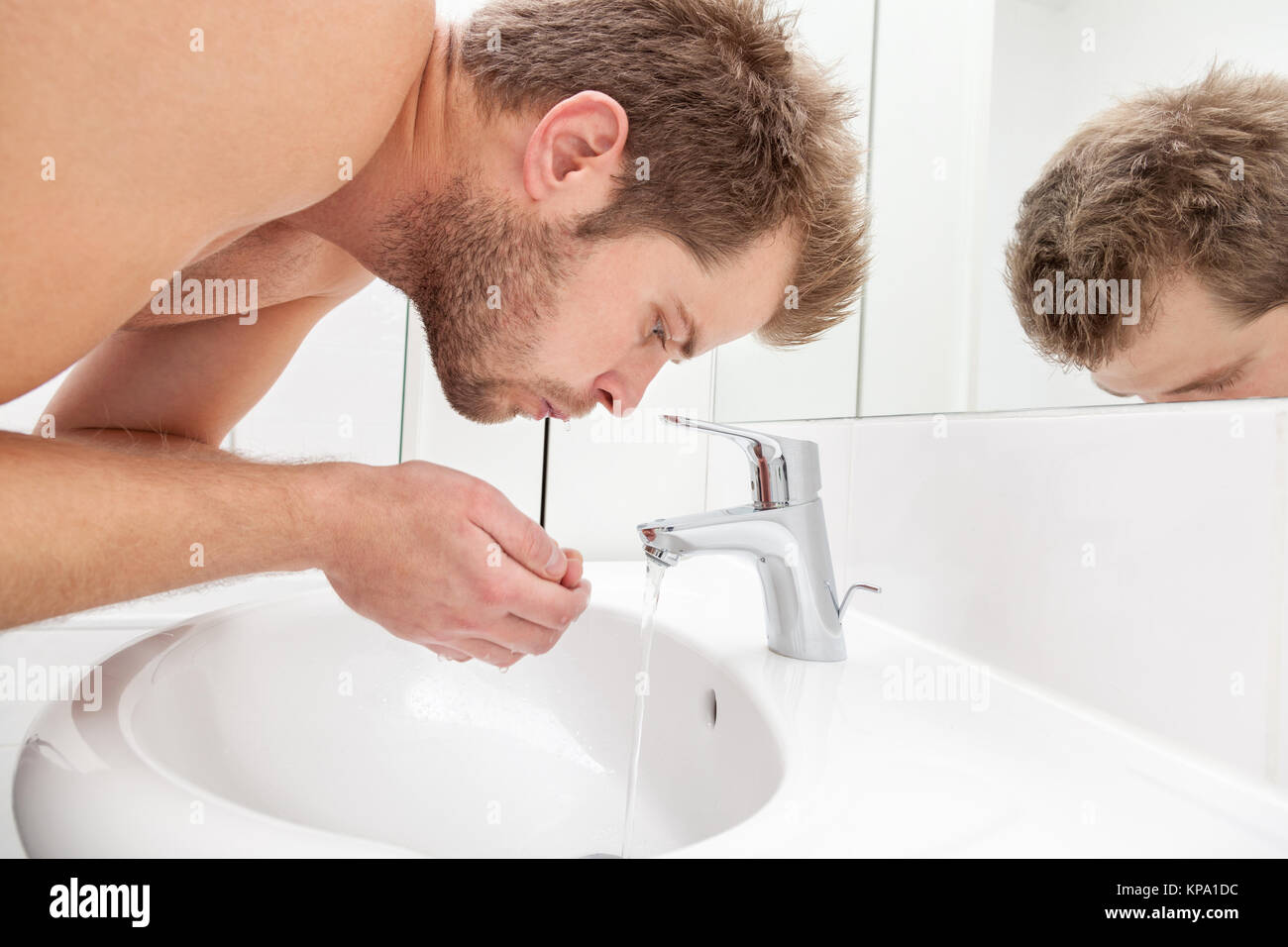 Man drinks tap water Stock Photo - Alamy