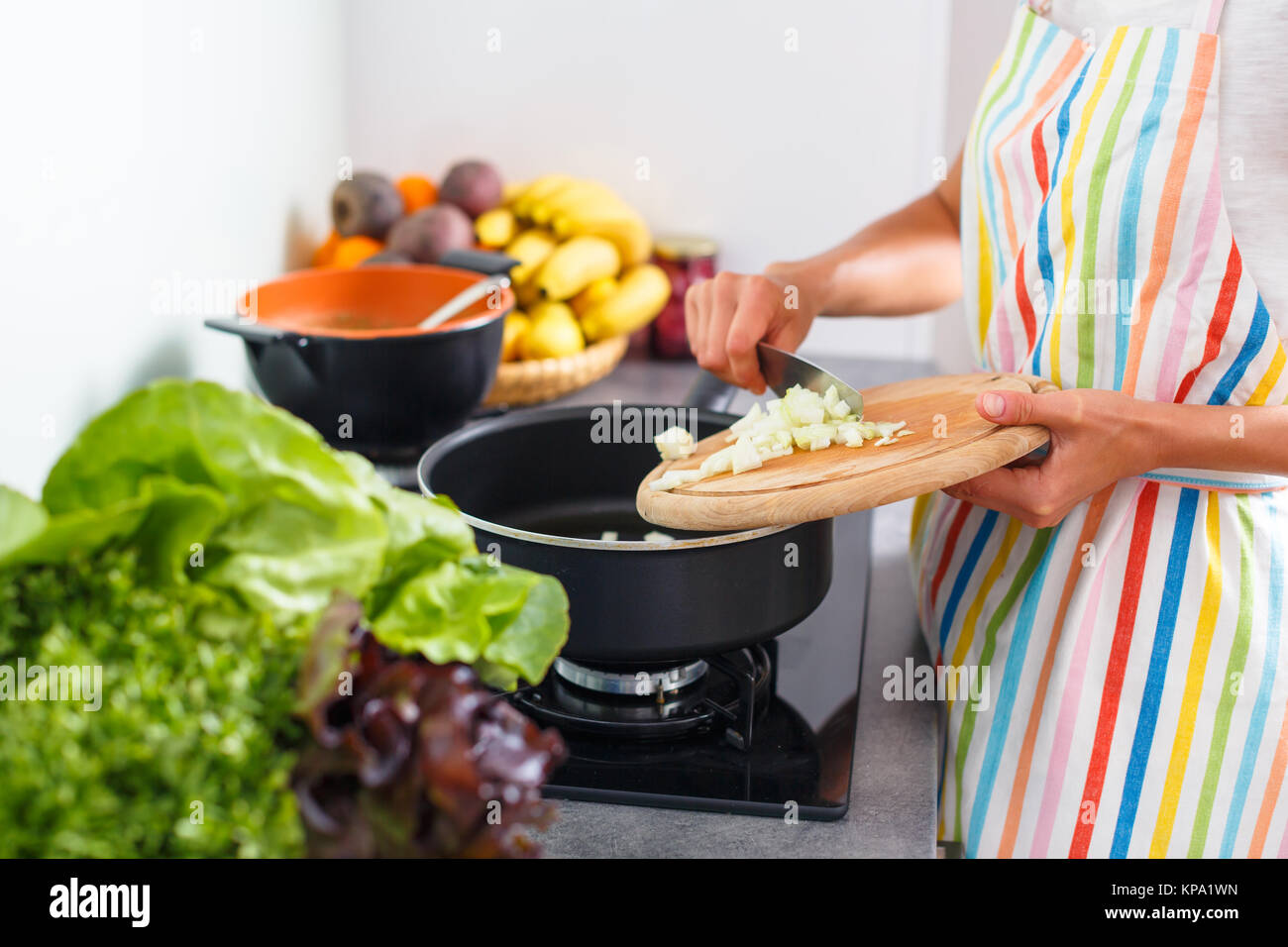 Young woman cooking in her modern kitchen Stock Photo - Alamy