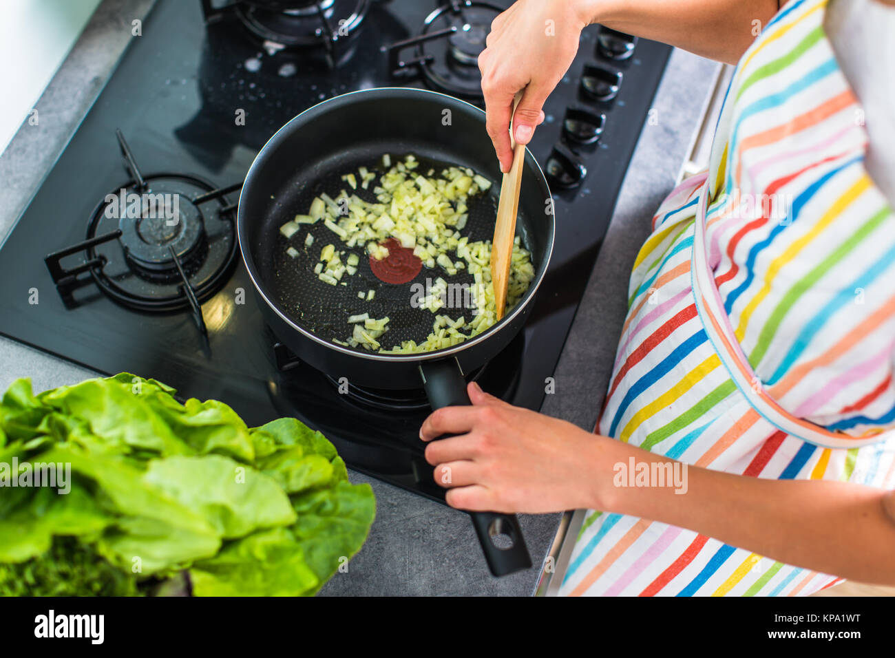 Young woman cooking in her modern kitchen Stock Photo - Alamy