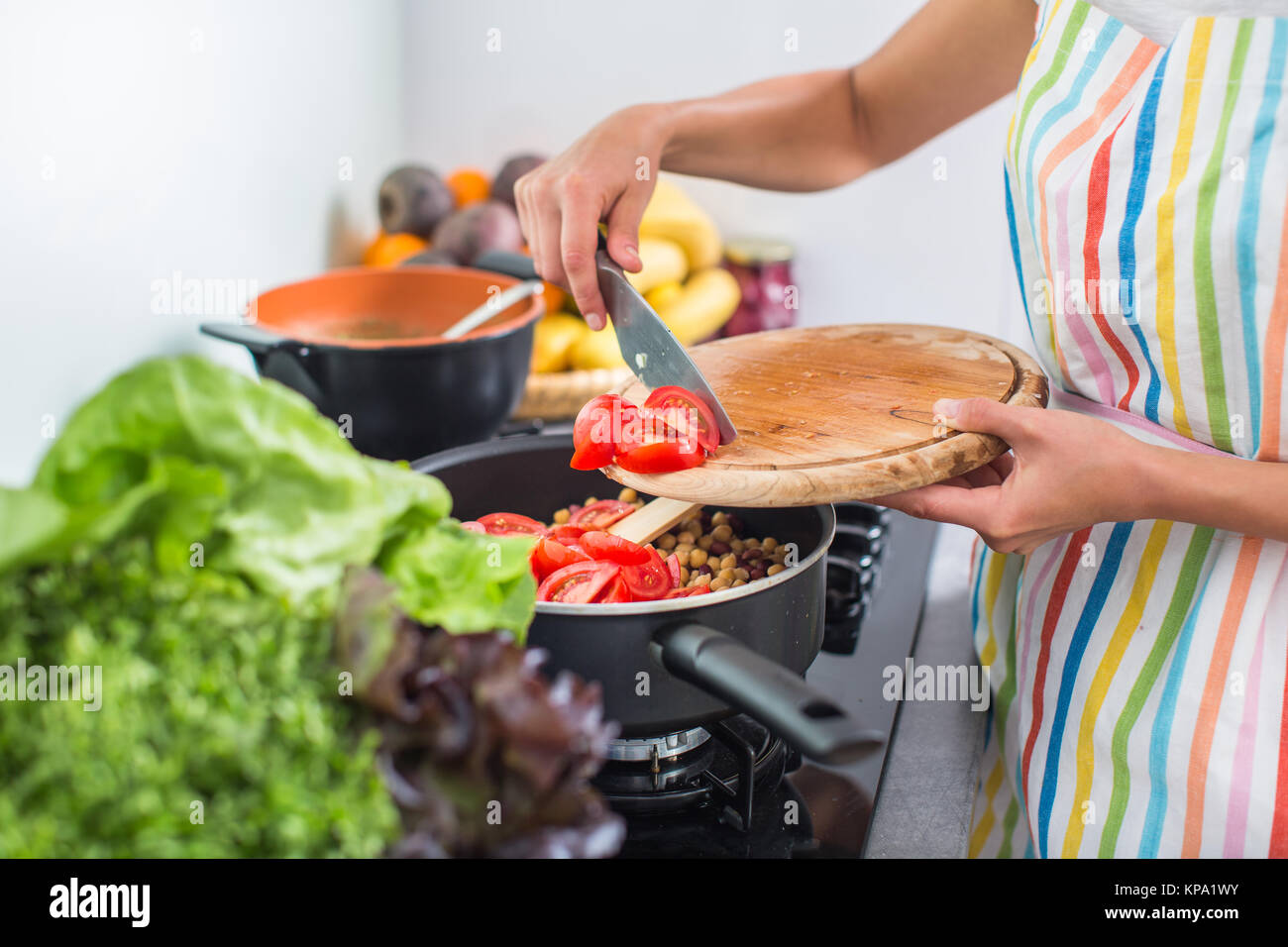 Young woman cooking in her modern kitchen Stock Photo - Alamy