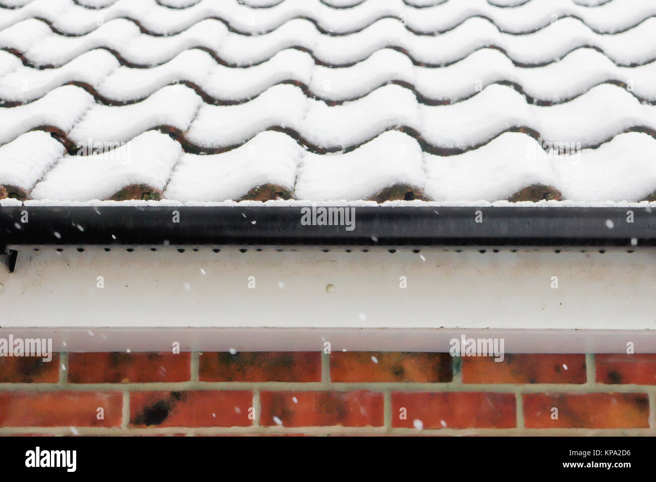 Part of the exterior of a modern garage with snow on the roof Stock ...