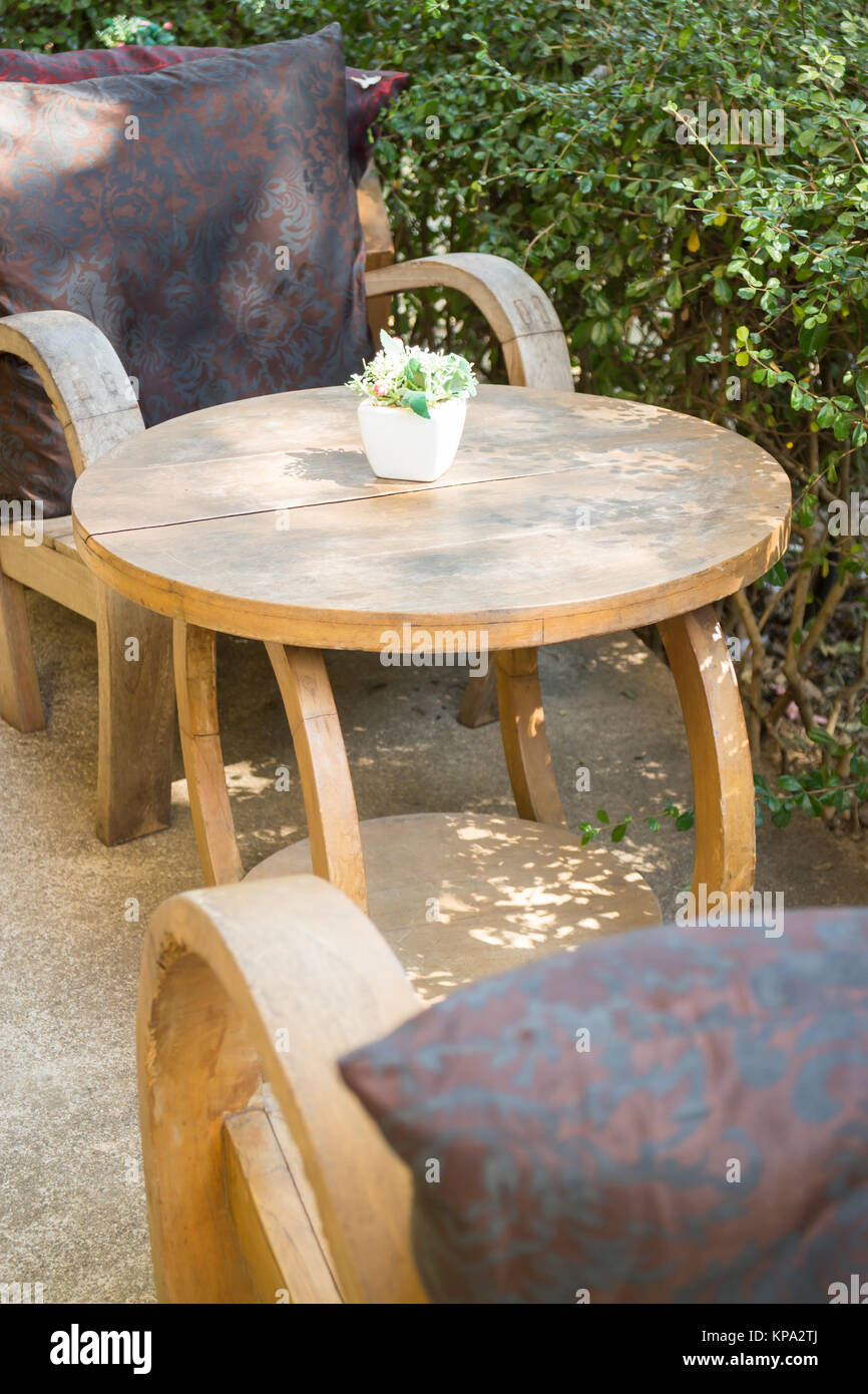 Table and chairs standing in the garden with shadows Stock Photo - Alamy