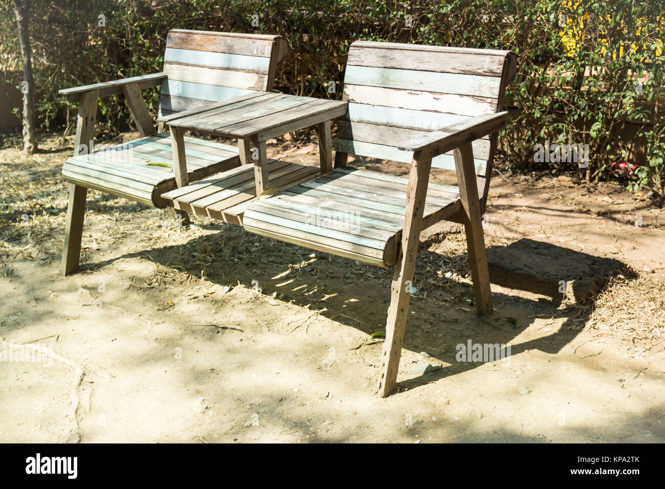 Double chairs standing in the garden with shadows Stock Photo - Alamy