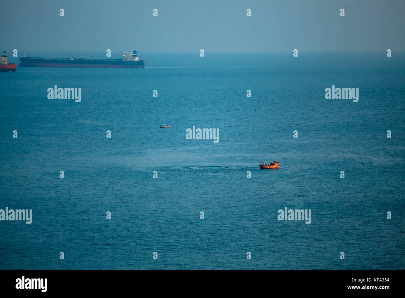 Traces from boats on the surface of the sea, in the distance a large ...