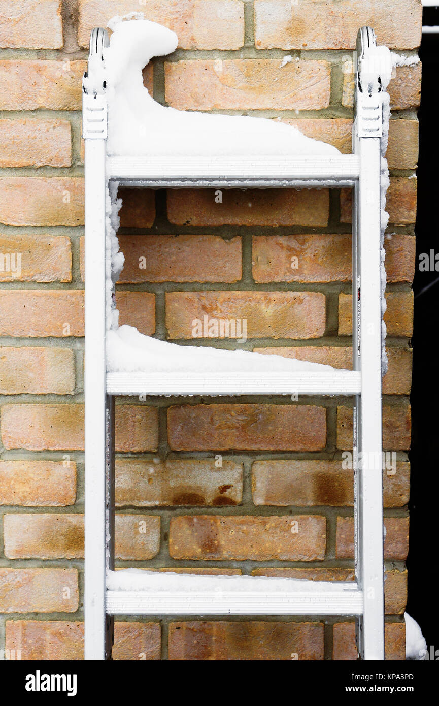 Part of a metal ladder with fresh snow Stock Photo - Alamy