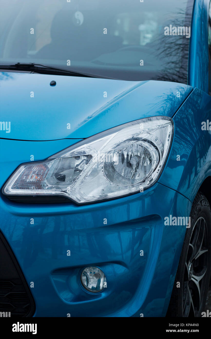 Car headlight on passenger blue car Stock Photo - Alamy