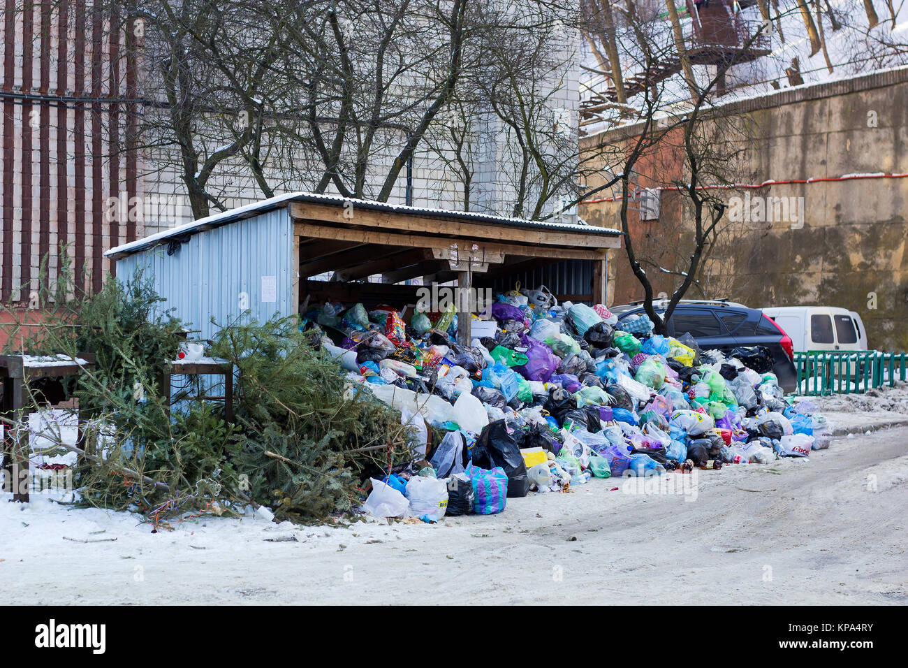 Metal hangar and garbage cans covered of large heap garbage on city ...