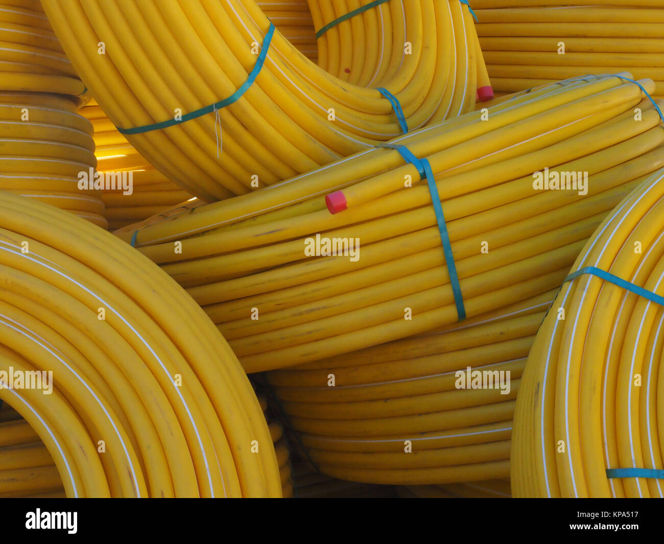 Large bobbins of the yellow electrical cable, coiled, are a heap Stock ...